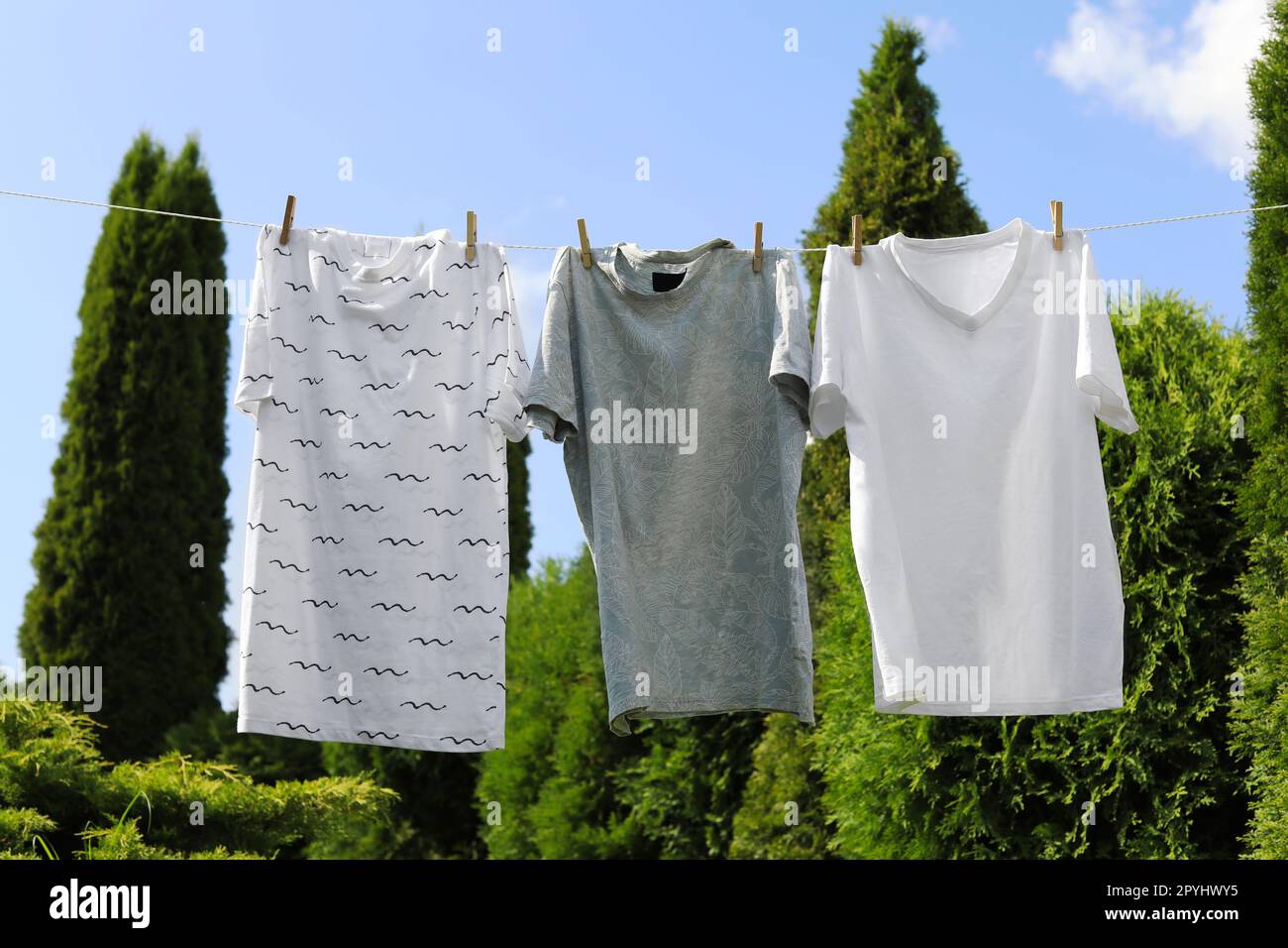 Washing line with clean clothes in garden. Drying laundry outside Stock ...