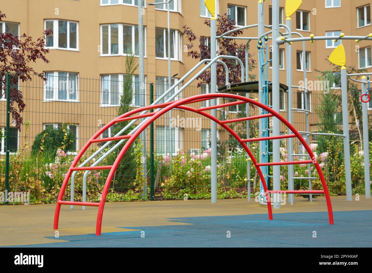 Red curved ladder on outdoor playground in residential area Stock Photo ...