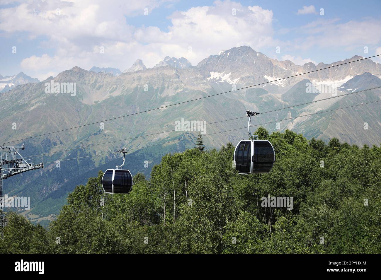 View of cableway with modern cabins in mountains Stock Photo - Alamy