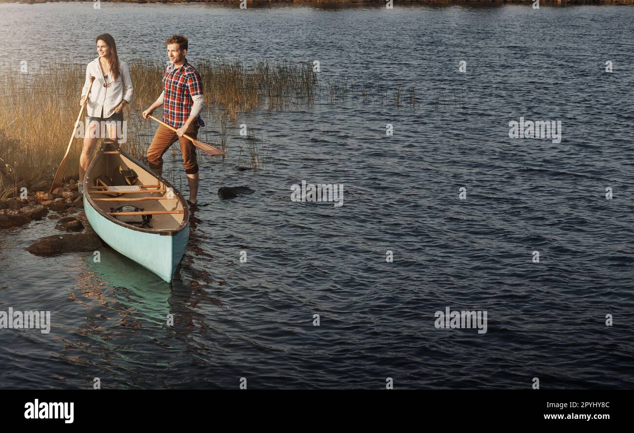 The lake draws them back every summer. a young couple going for a canoe ...