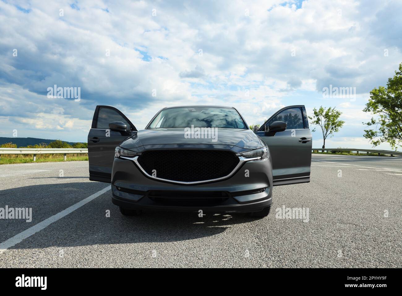 New black modern car with open doors on asphalt road Stock Photo - Alamy