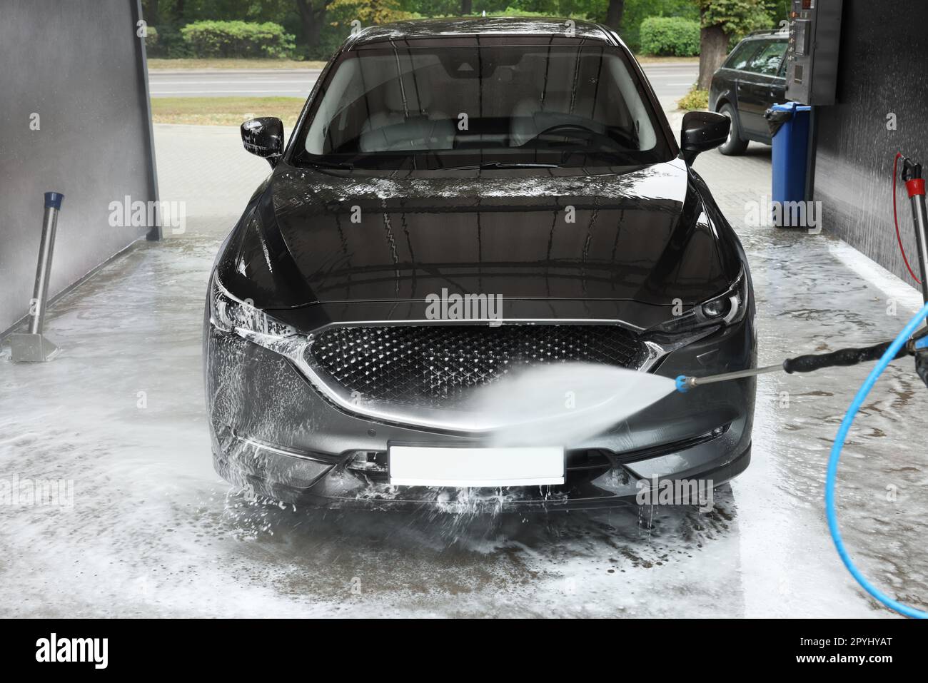 Washing auto with high pressure water jet at outdoor car wash Stock ...