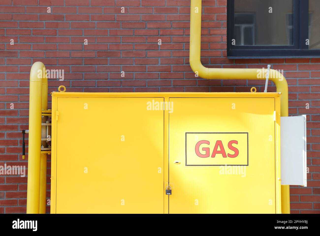 Gas distribution system with pipes near red brick wall outdoors Stock ...