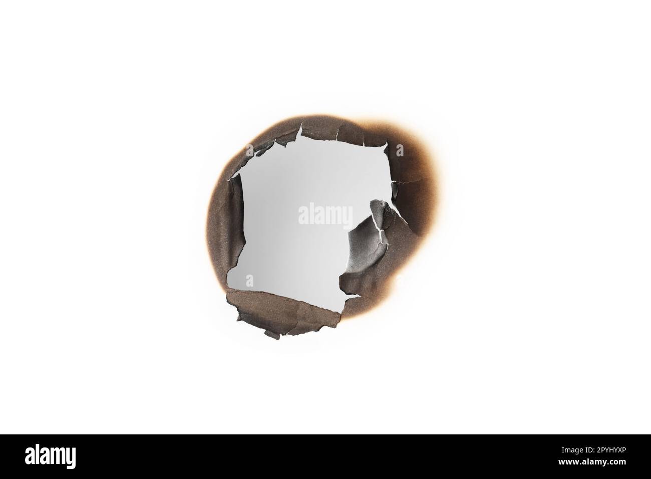 Burnt hole in paper on white background Stock Photo - Alamy
