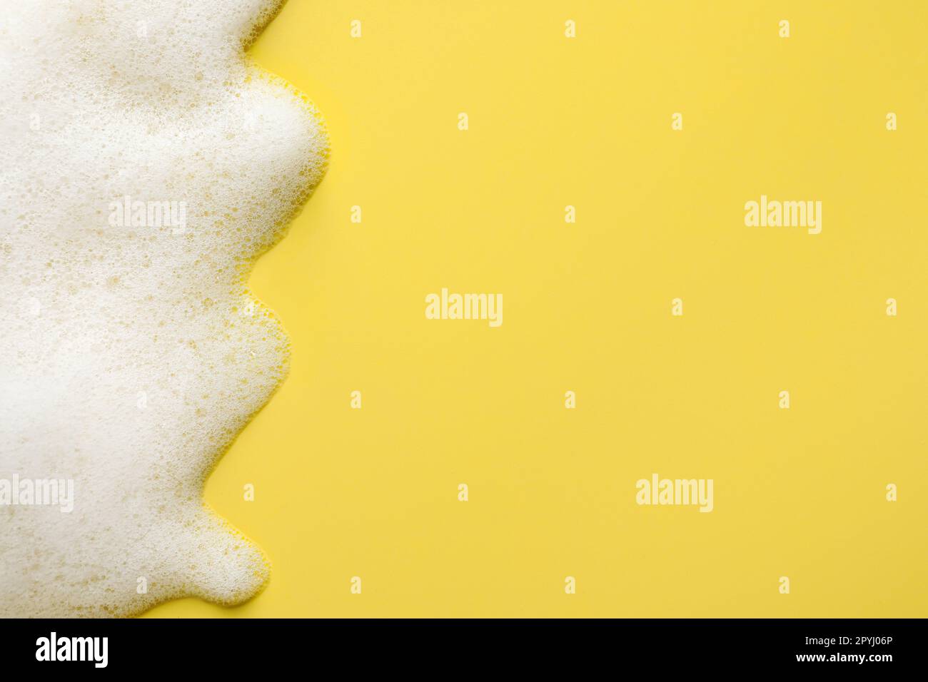 Fluffy soap foam on yellow background, top view. Space for text Stock ...