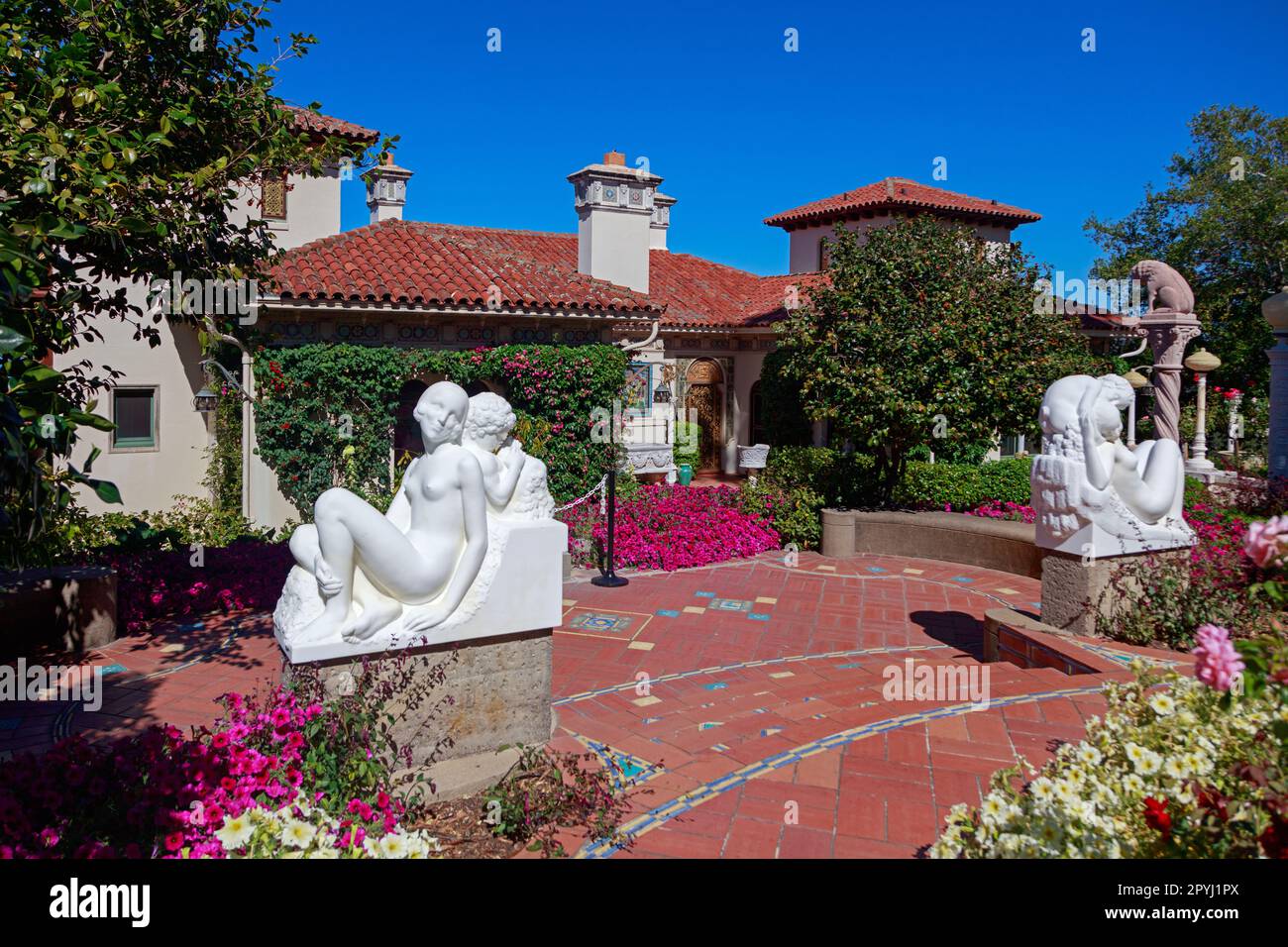 Marble statues on display in a garden at the guest house of Hearst ...