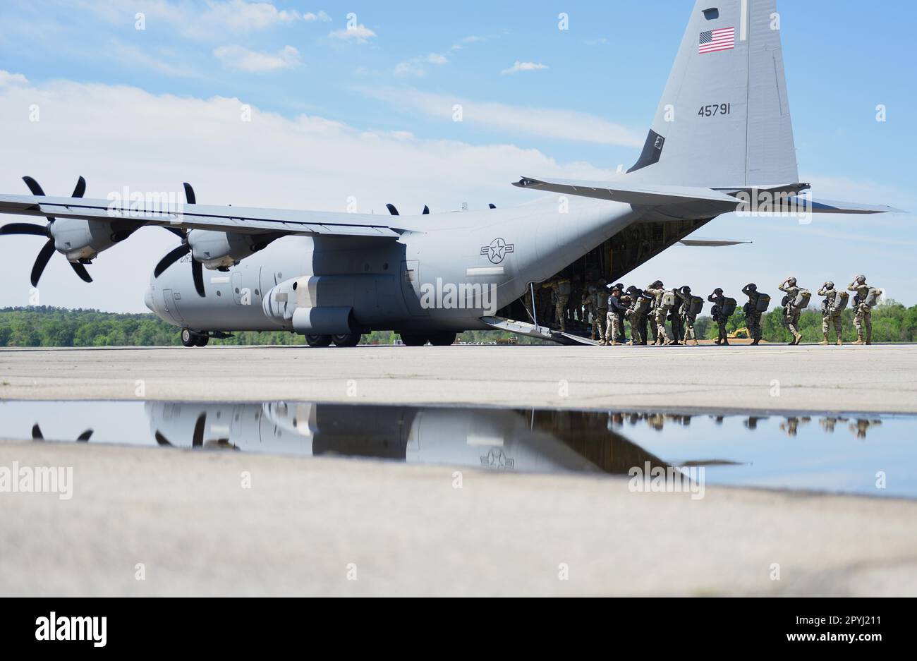 Airborne students board a C-130 cargo aircraft as they prepare to make ...