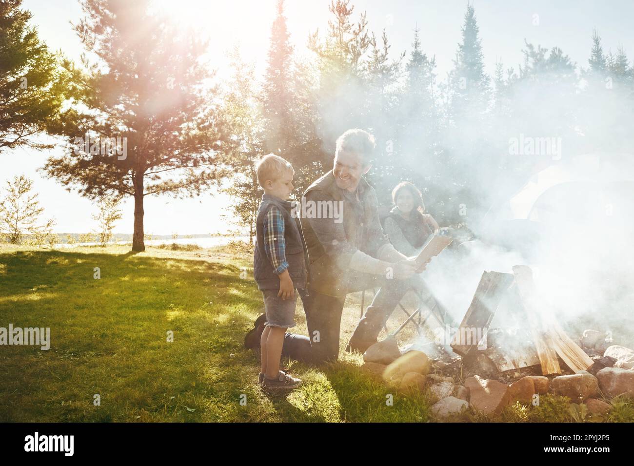 Nature is one of the best places to bond. a young family camping in the ...