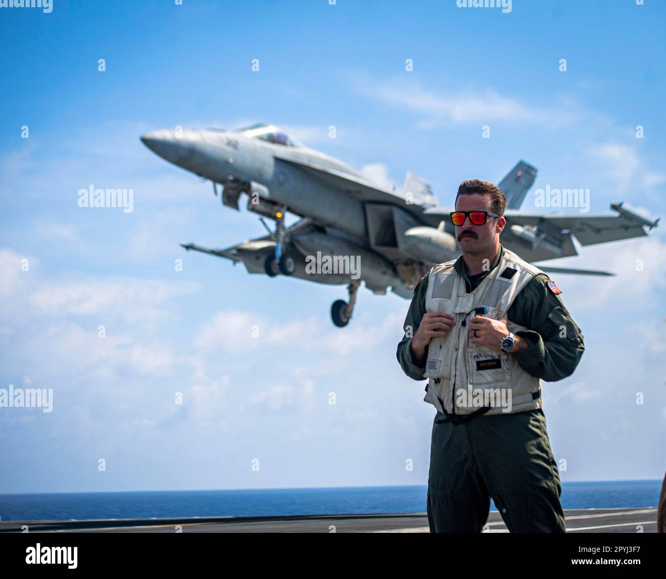 230502-N-MH015-1073 SOUTH CHINA SEA (May 2, 2023) A U.S. Navy Sailor observes flight operations ...