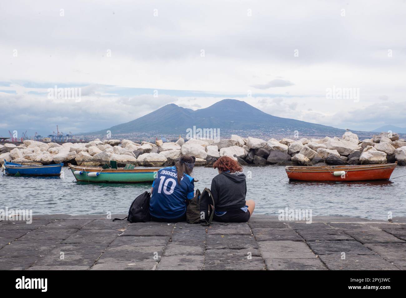 Naples, Italy. 3rd May, 2023. Girls sitting facing the sea in Naples ...
