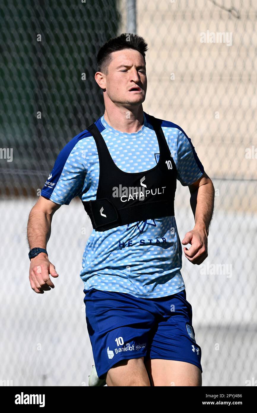 Joseph Lolley of Sydney FC works with a trainer during a team training ...
