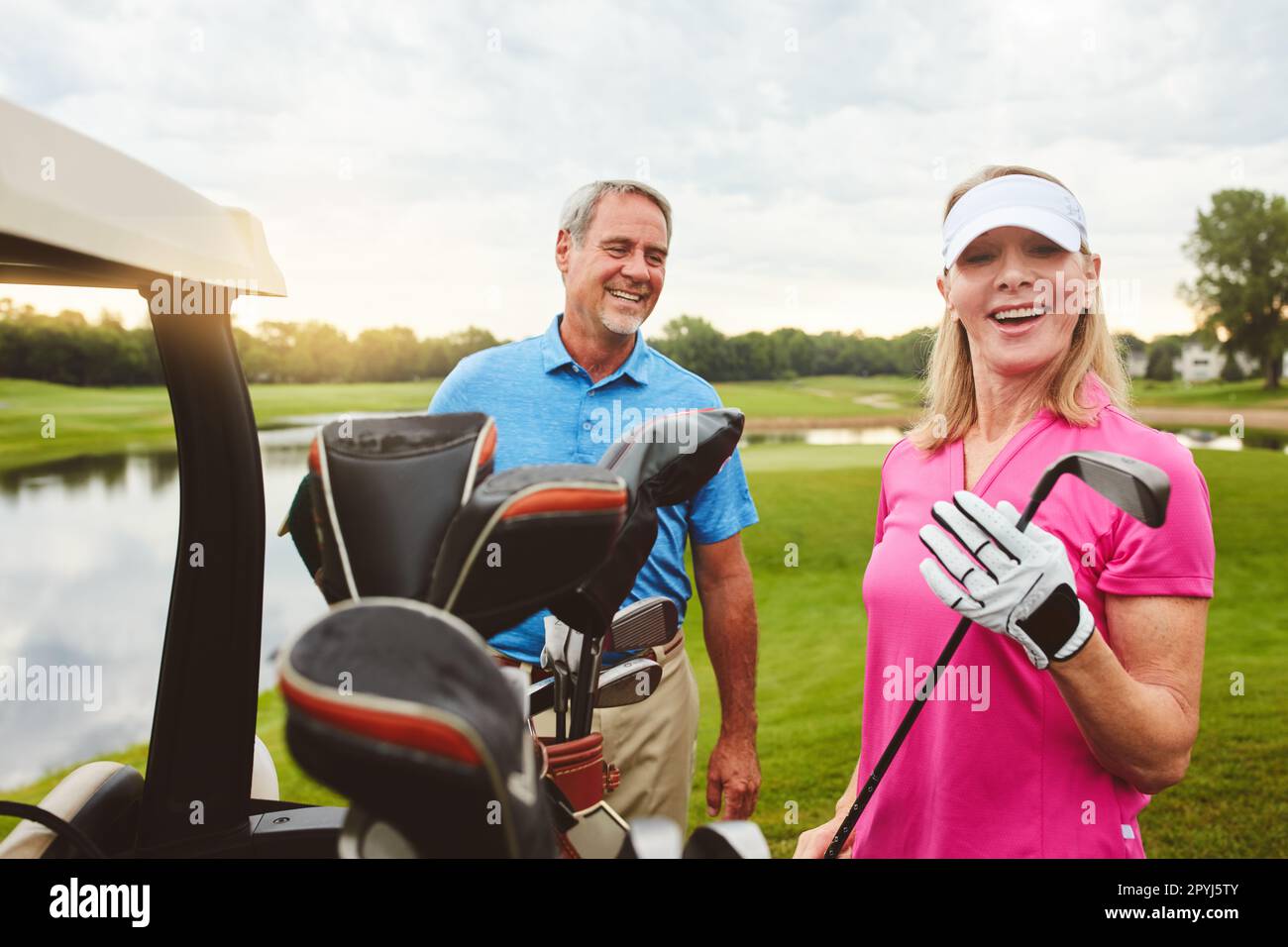 Couples golf. an affectionate mature couple spending a day on the golf course Stock Photo - Alamy
