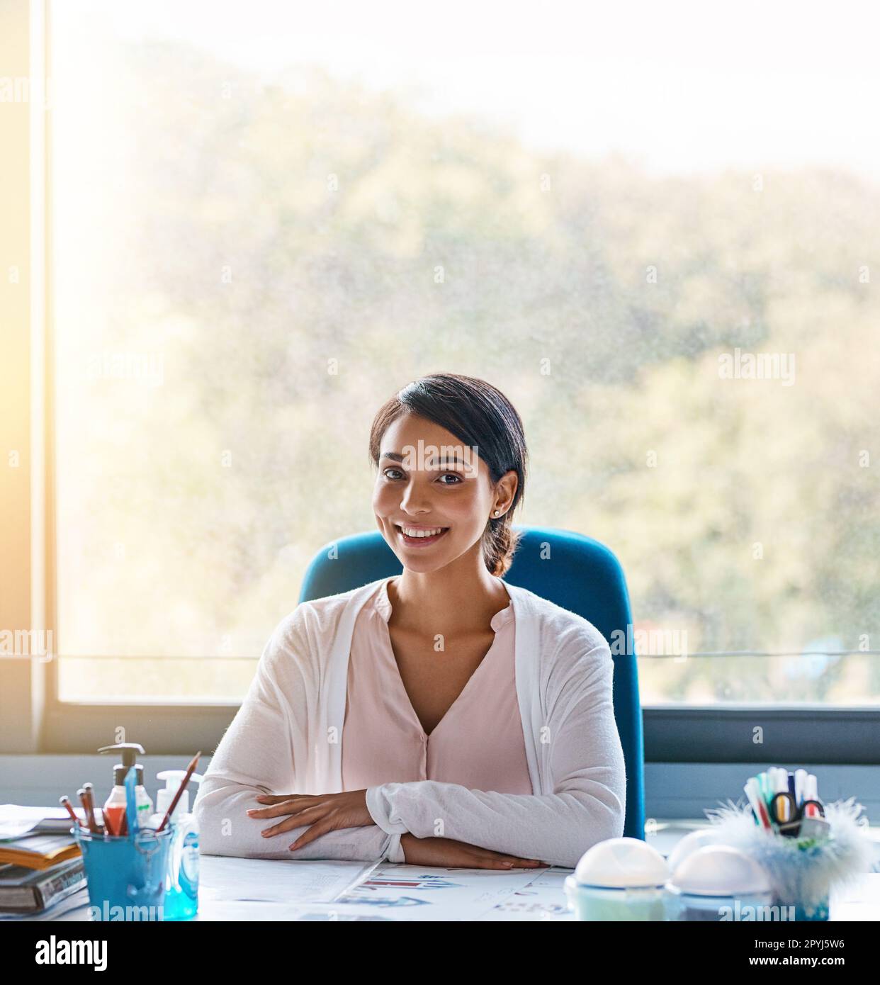 Welcome to my desk. Portrait shot of a focussed young female teacher ...