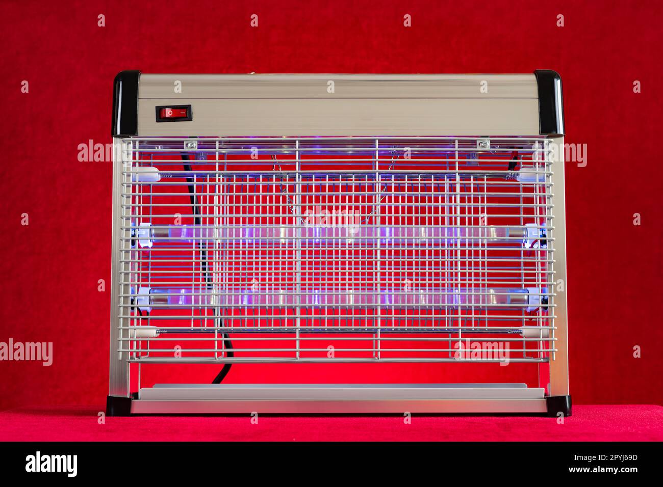 electric indoor mosquito and insect killer on red Stock Photo - Alamy
