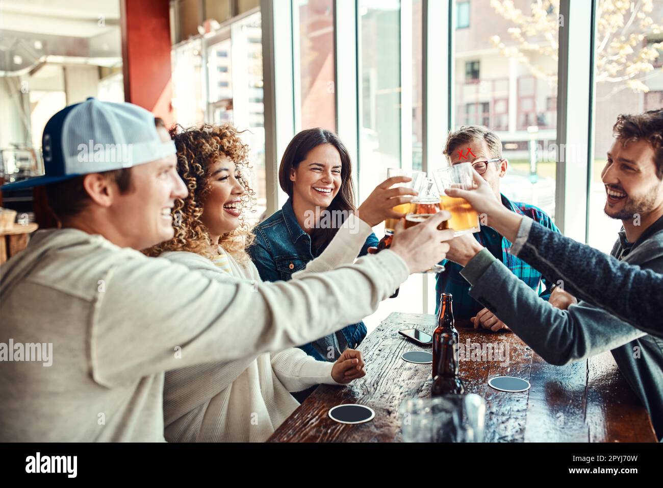 Great minds drink alike. a group of friends enjoying themselves at a ...