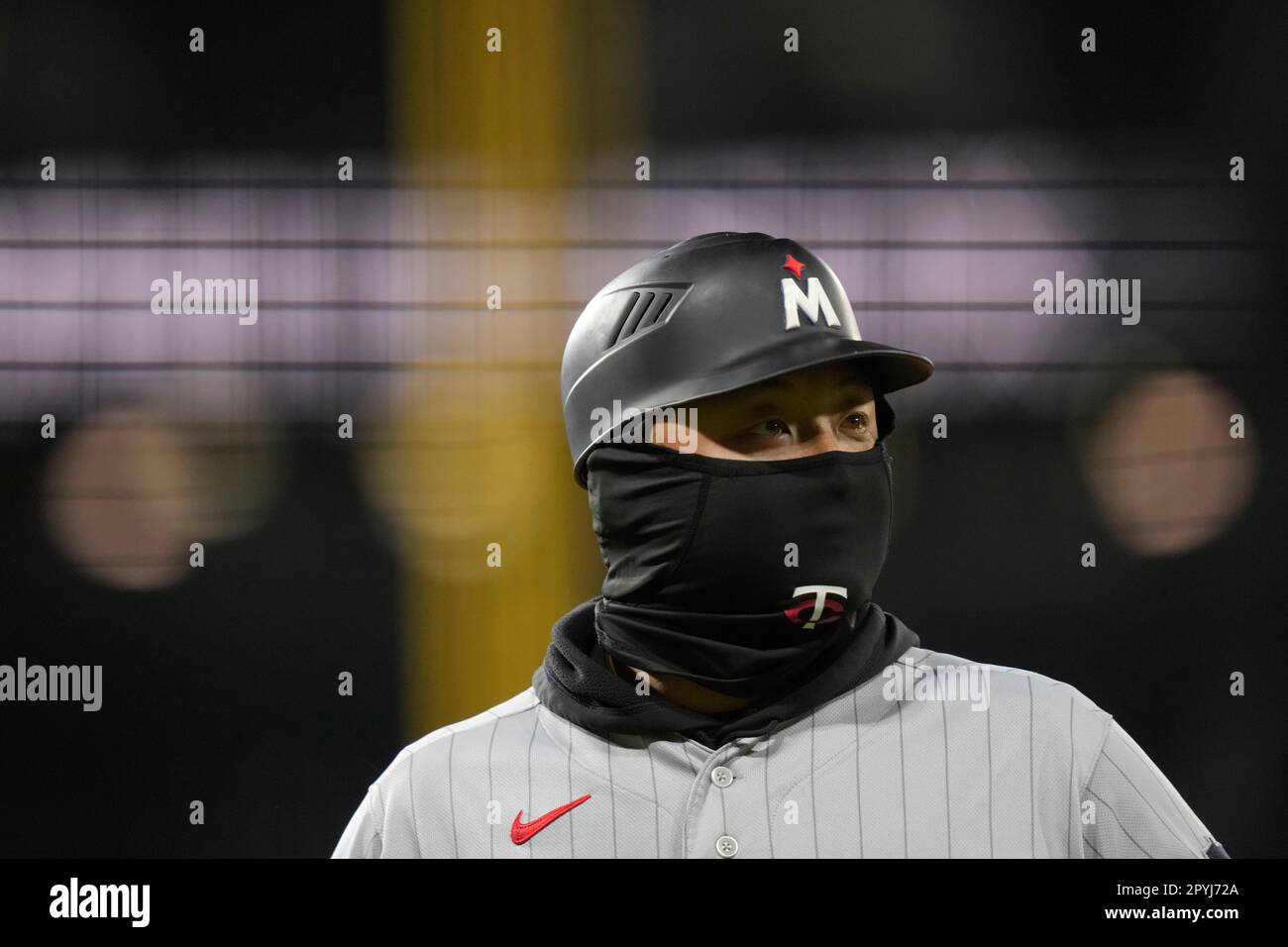 Minnesota Twins first base coach Hank Conger wears a balaclava to keep ...
