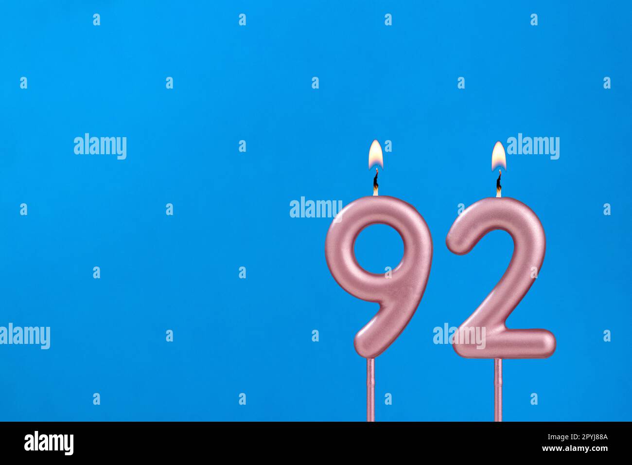 Candle number 92 - Birthday in blues foamy background Stock Photo - Alamy