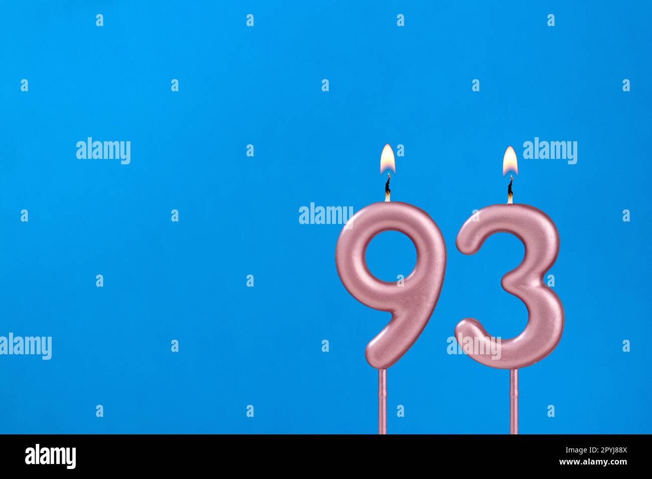 Number 93 - Burning anniversary candle on blue foamy background Stock ...