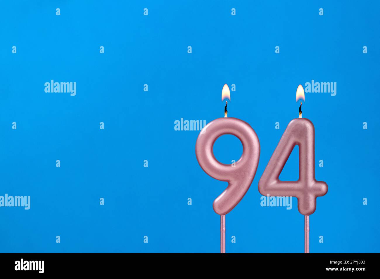 Candle number 94 - Birthday in blues foamy background Stock Photo - Alamy