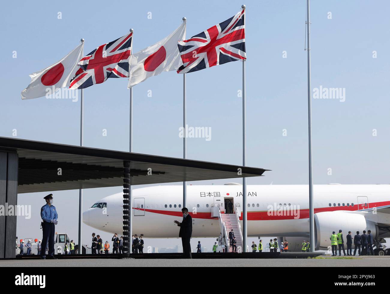 A photo shows the Union Jack and Japanese national flag in front of ...