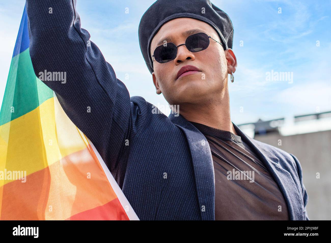 Gay activist holding a LGBT rainbow flag. Concept of Pride. Pride month ...