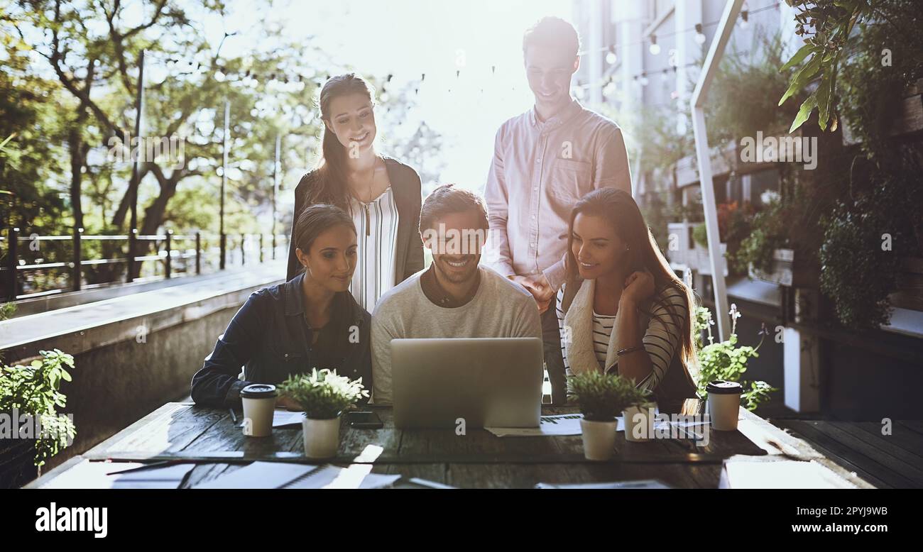 Gathered to get a team task completed. a team of colleagues using a ...