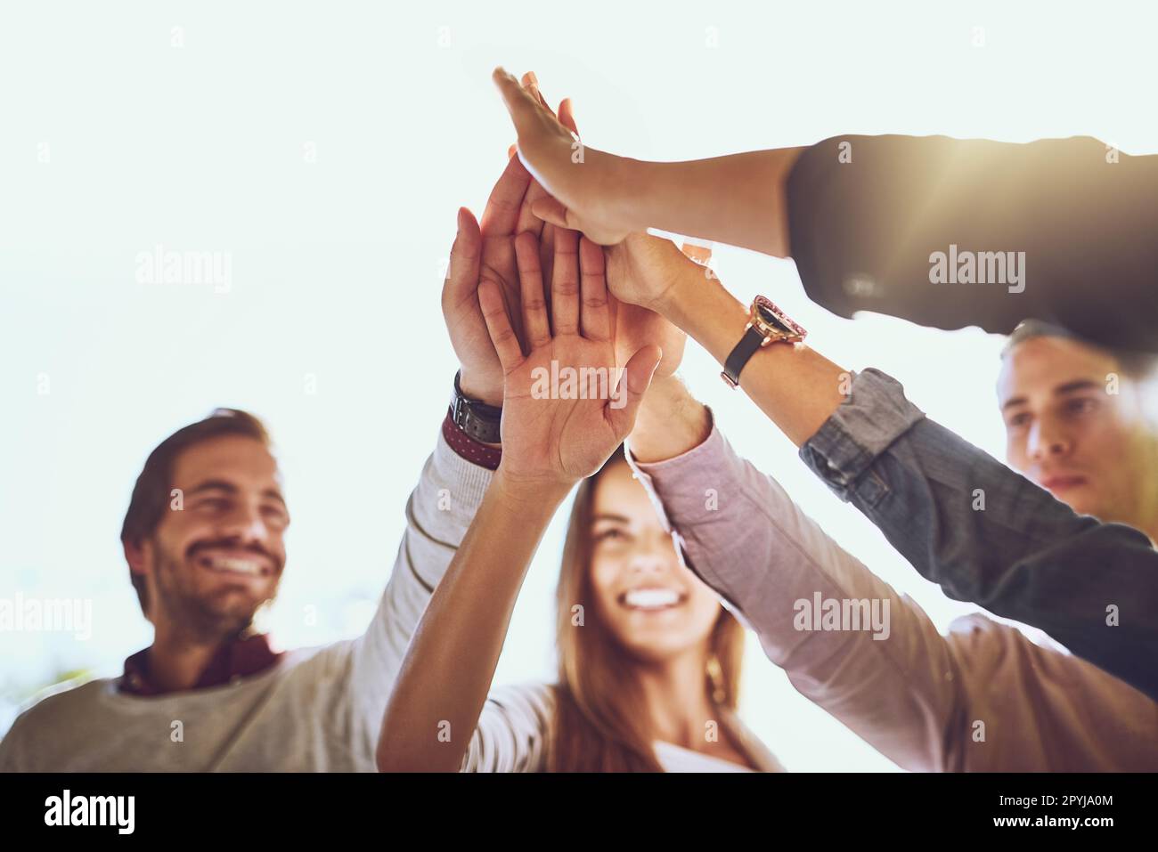 Winners create winning teams. a group of colleagues joining hands in ...