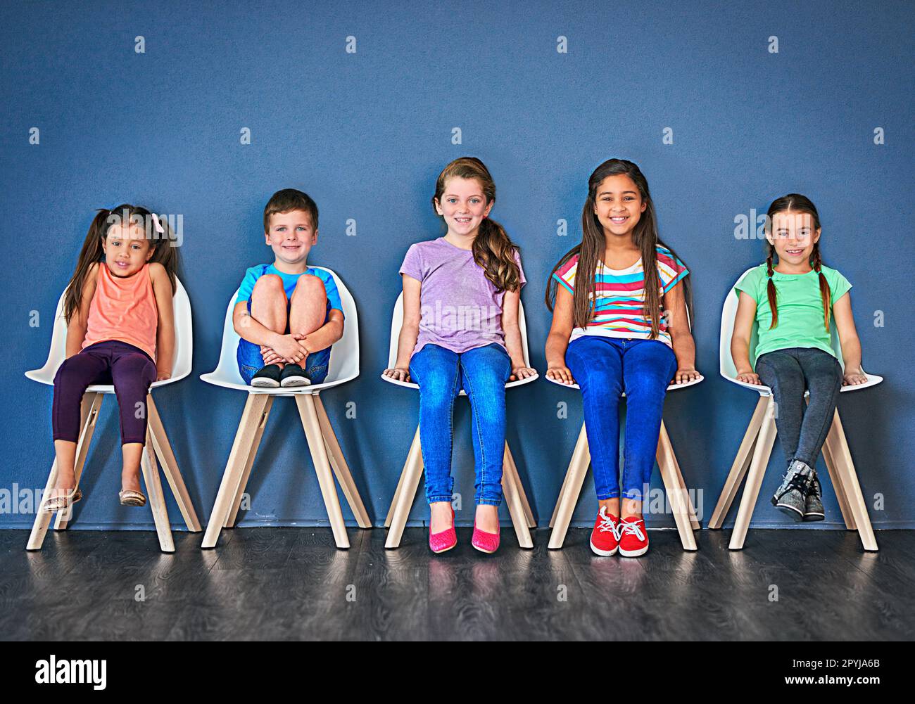 Its our turn now. Studio shot of a diverse group of kids sitting on ...