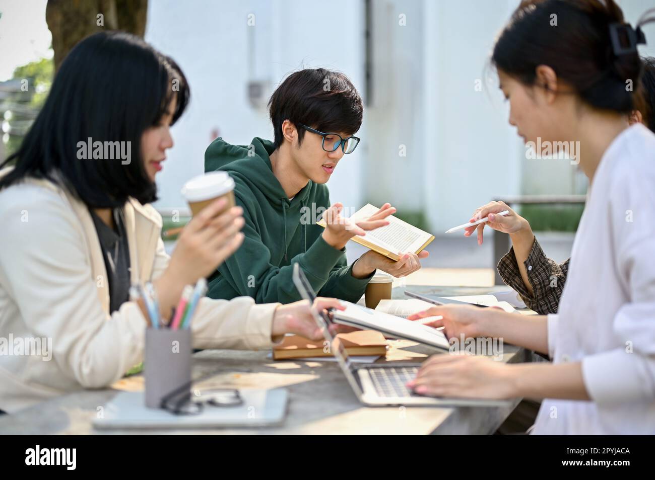 Image of a group of college students preparing for the exam together, A ...