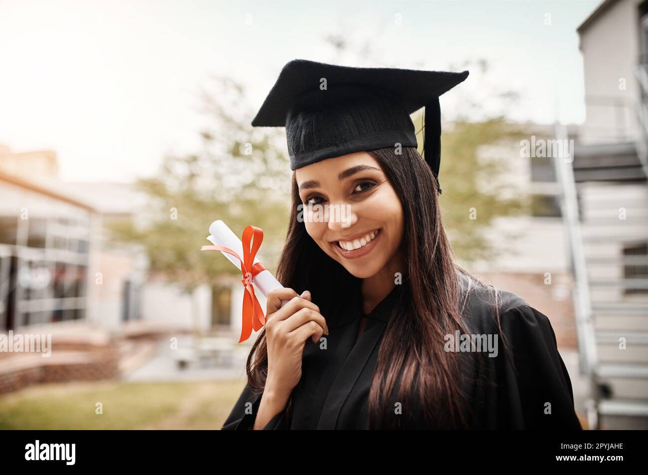 Proud to be graduating. Portrait of a female student on graduation day ...
