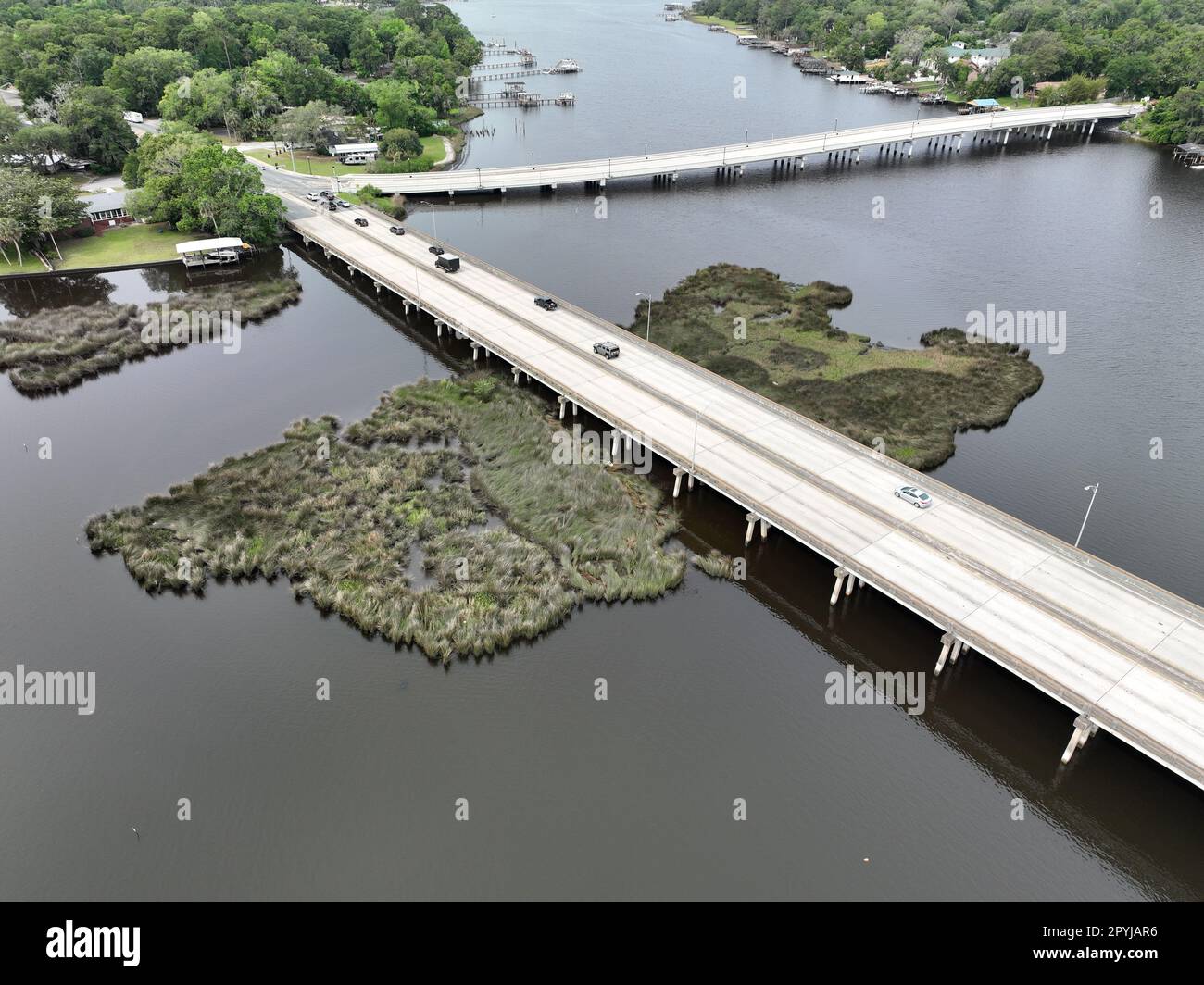 A bird eye view of a highway bridge connecting two land masses across a ...
