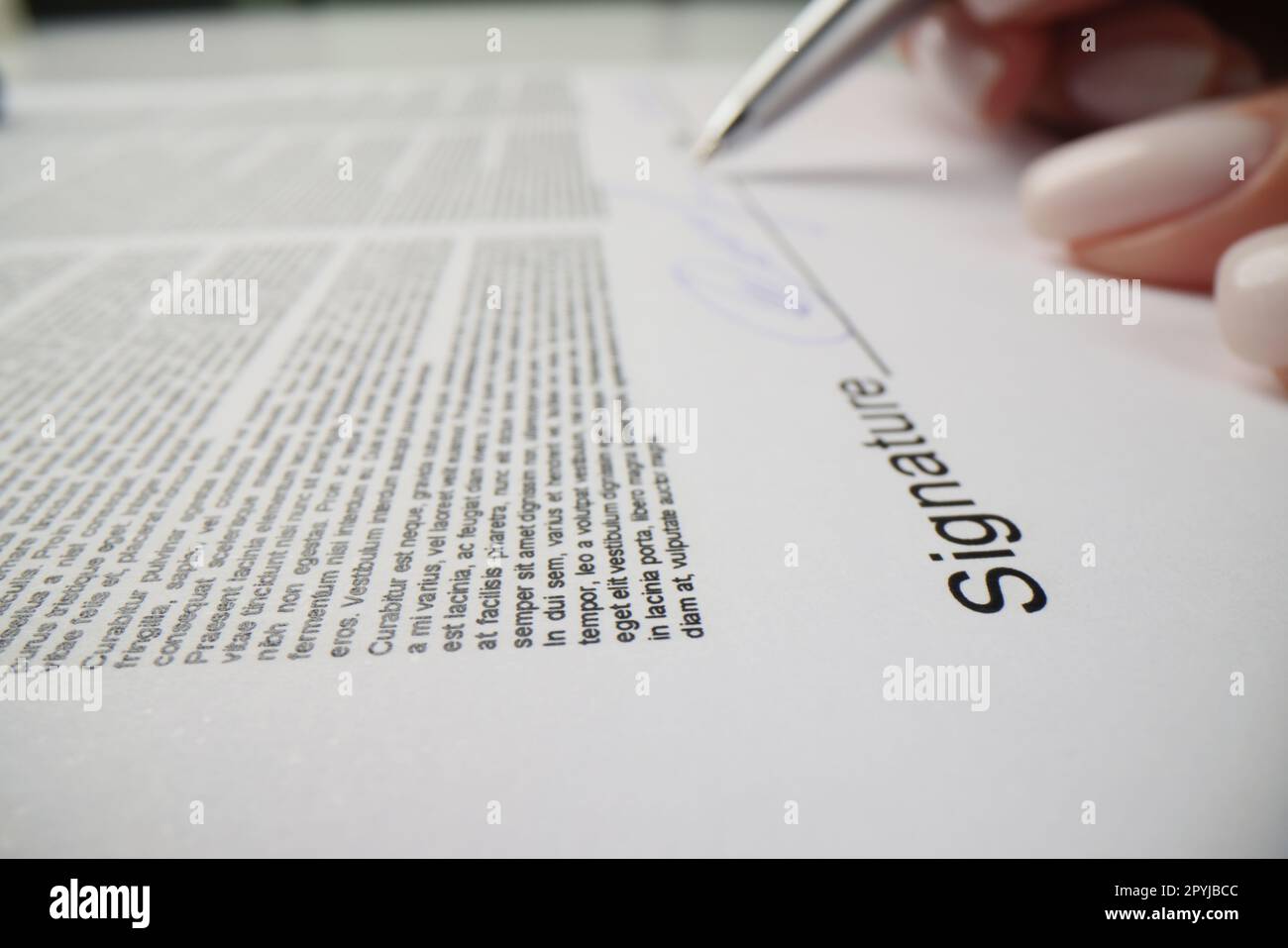 Woman puts personal signature above line on paper sheet Stock Photo - Alamy