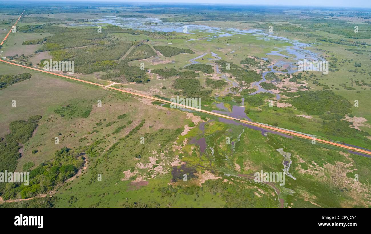 Aerial view of Transpantaneira dirt road crossing in typical Pantanal ...