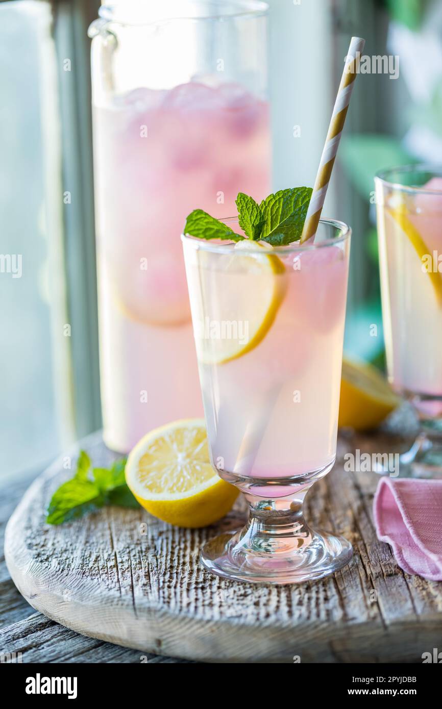 Cold and refreshing glass of lemonade with pink lemonade ice cubes Stock Photo - Alamy