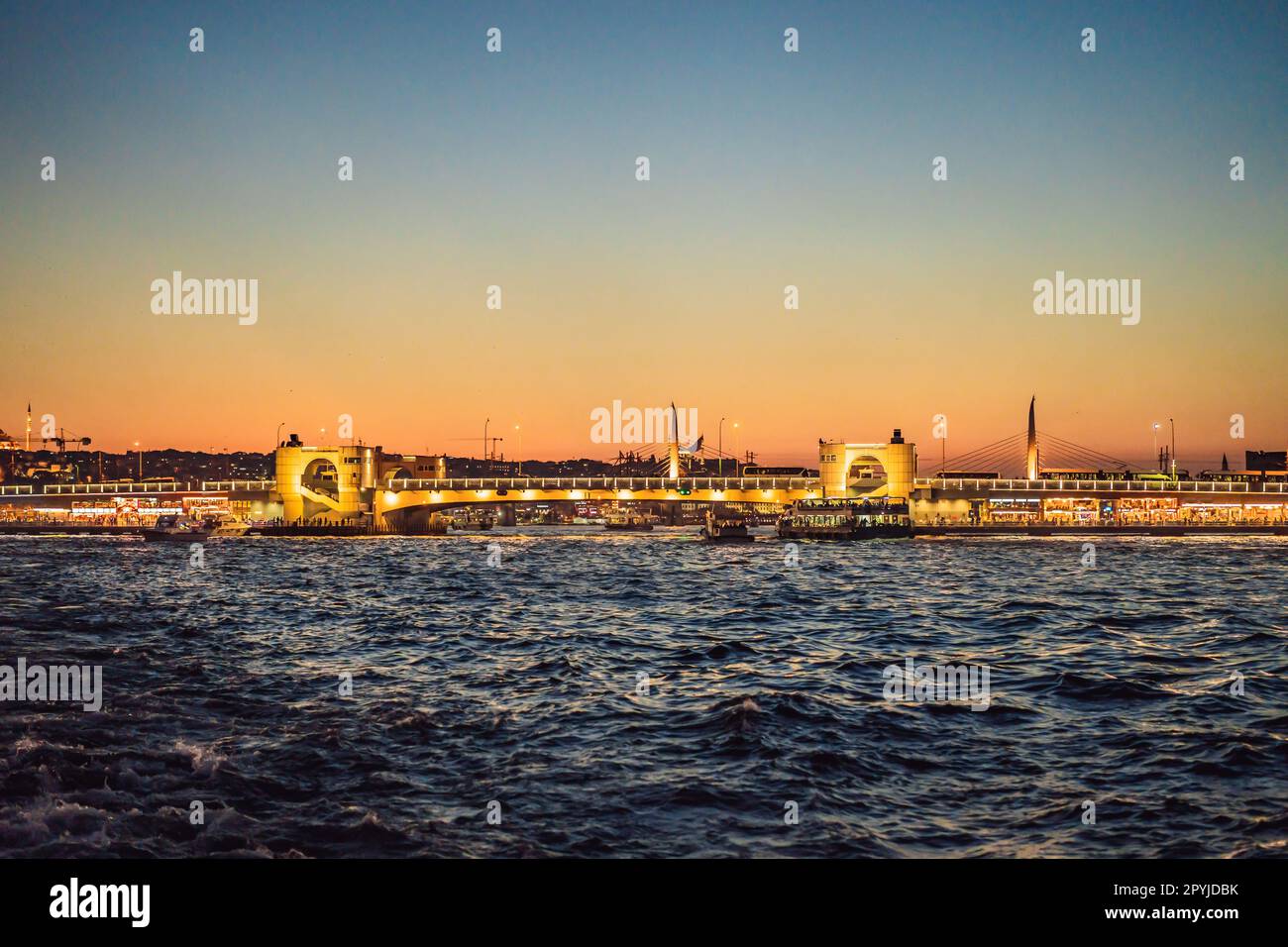 Istanbul at sunset, Turkey. Tourist boat sails on Golden Horn in summer ...