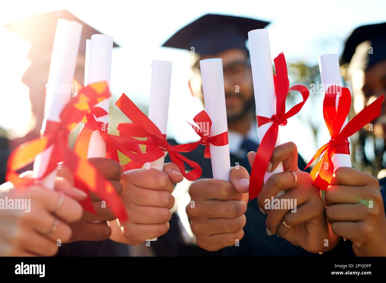 Hard work earned us this. a group of university students holding their ...