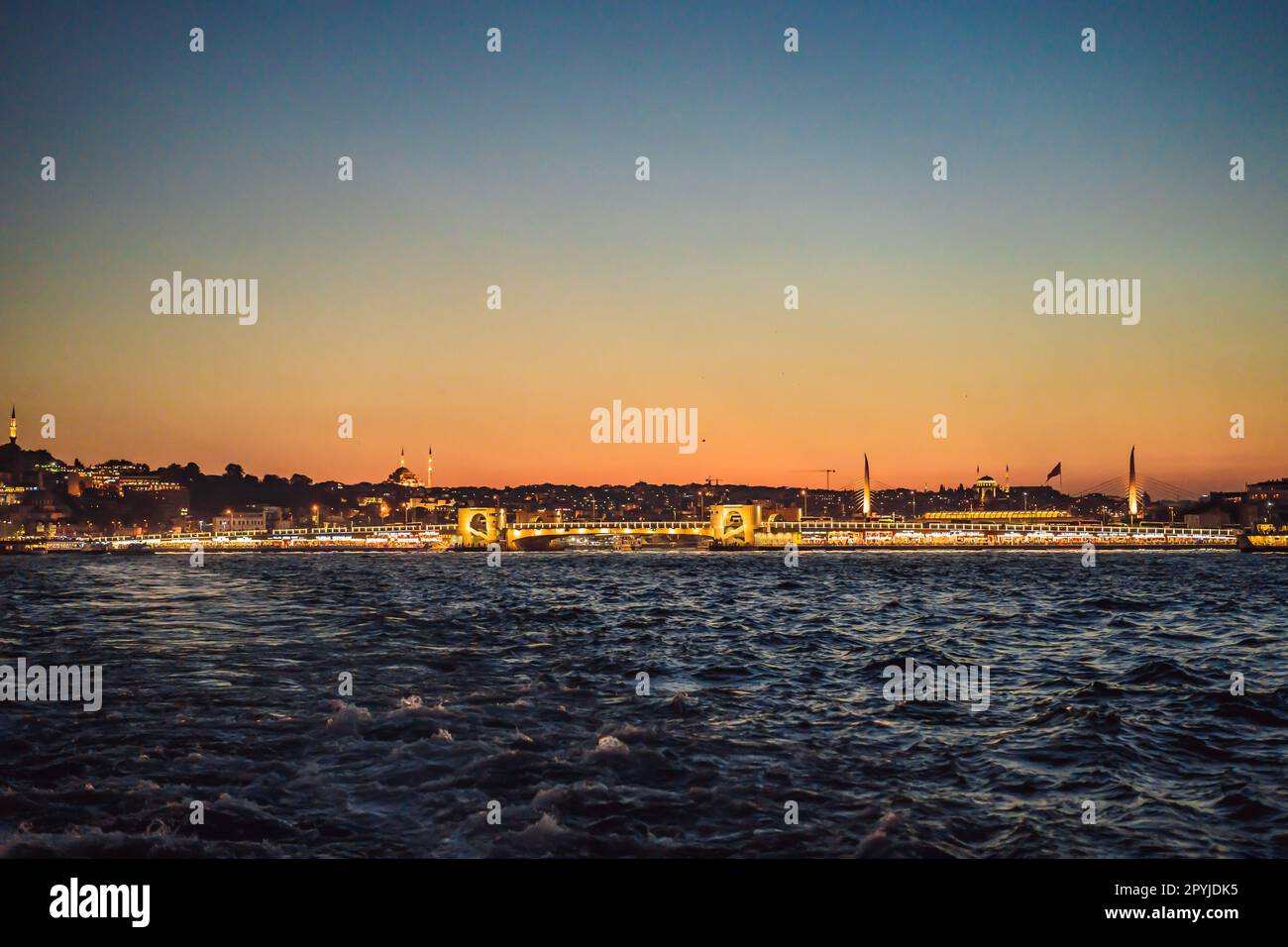 Istanbul at sunset, Turkey. Tourist boat sails on Golden Horn in summer ...