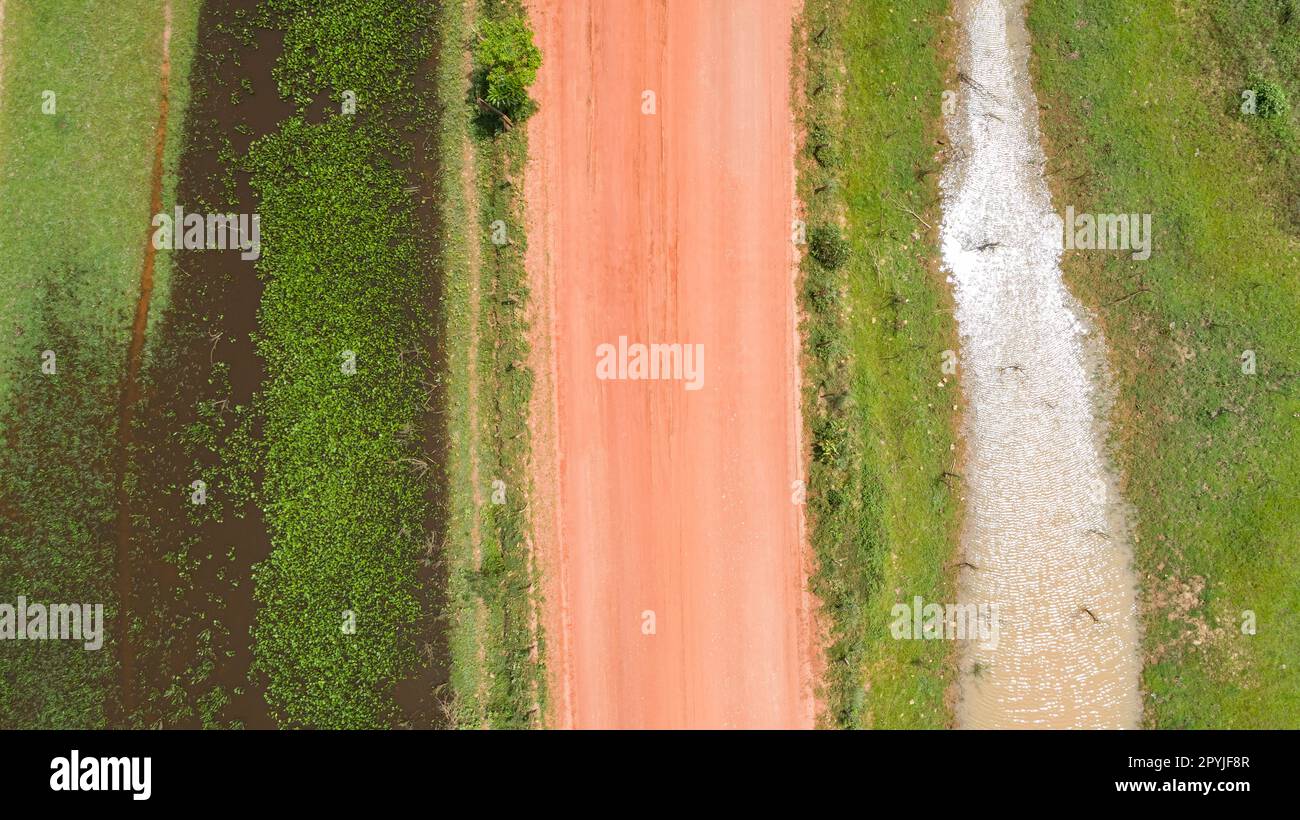 Close-up aerial view of Transpantaneira dirt road with lagoons and ...