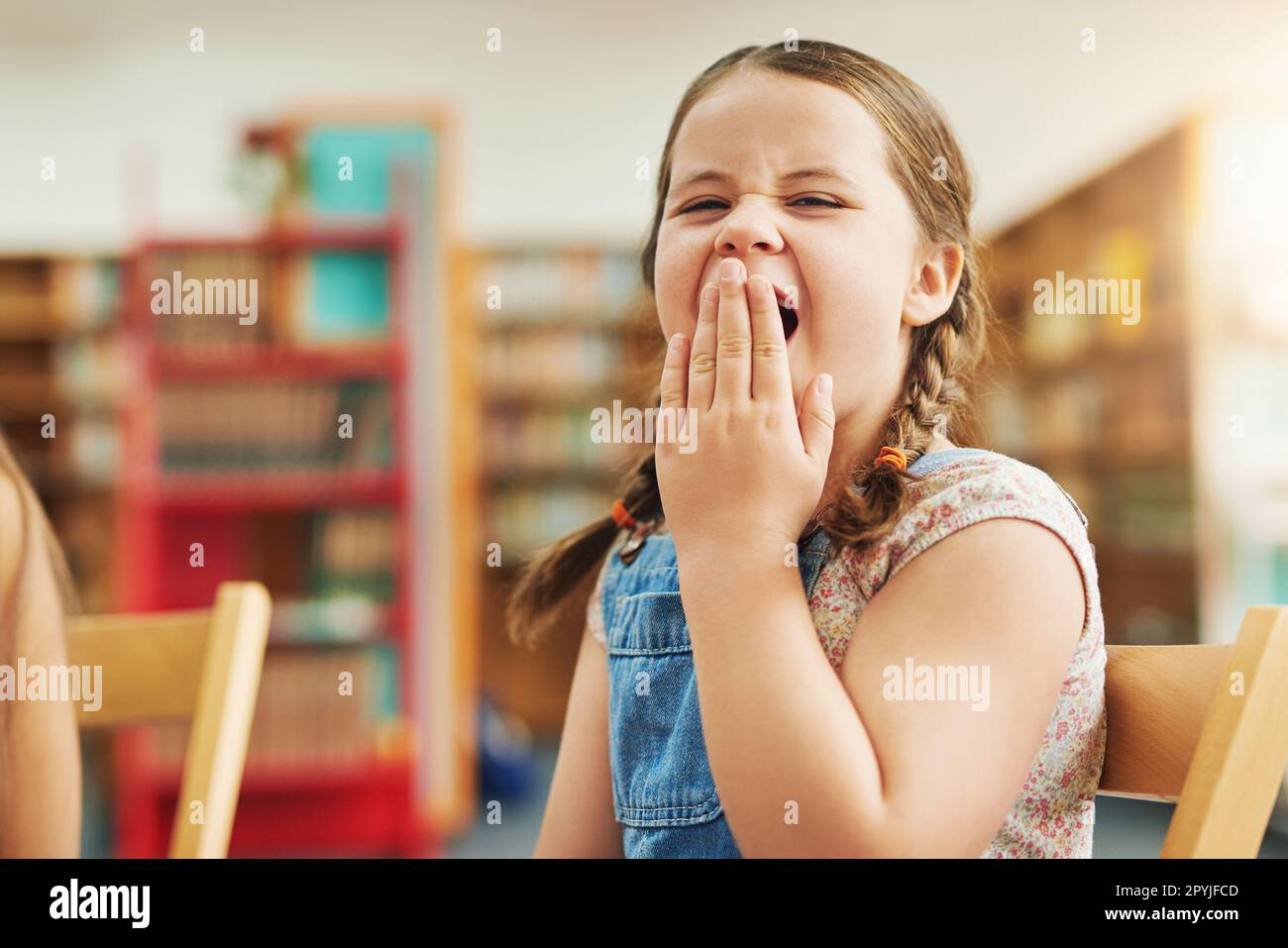Im getting a bit tired. Portrait of a tired young school girl yawning ...