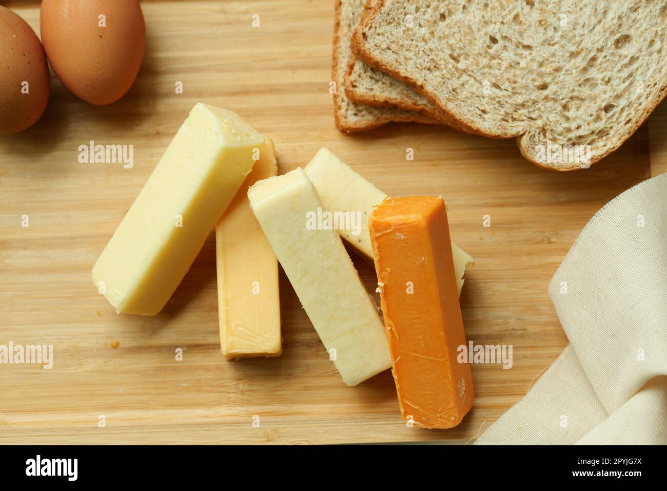 Cheese cubes green, yellow and red color on chopping board Stock Photo ...