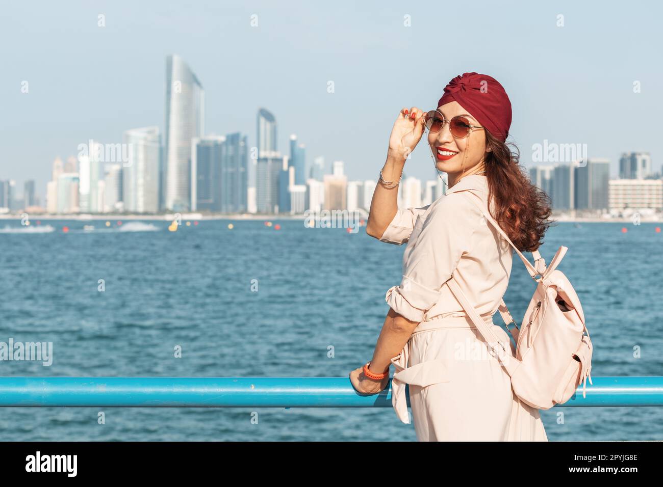 Indian Girl walking along the Corniche promenade in Abu Dhabi, UAE ...