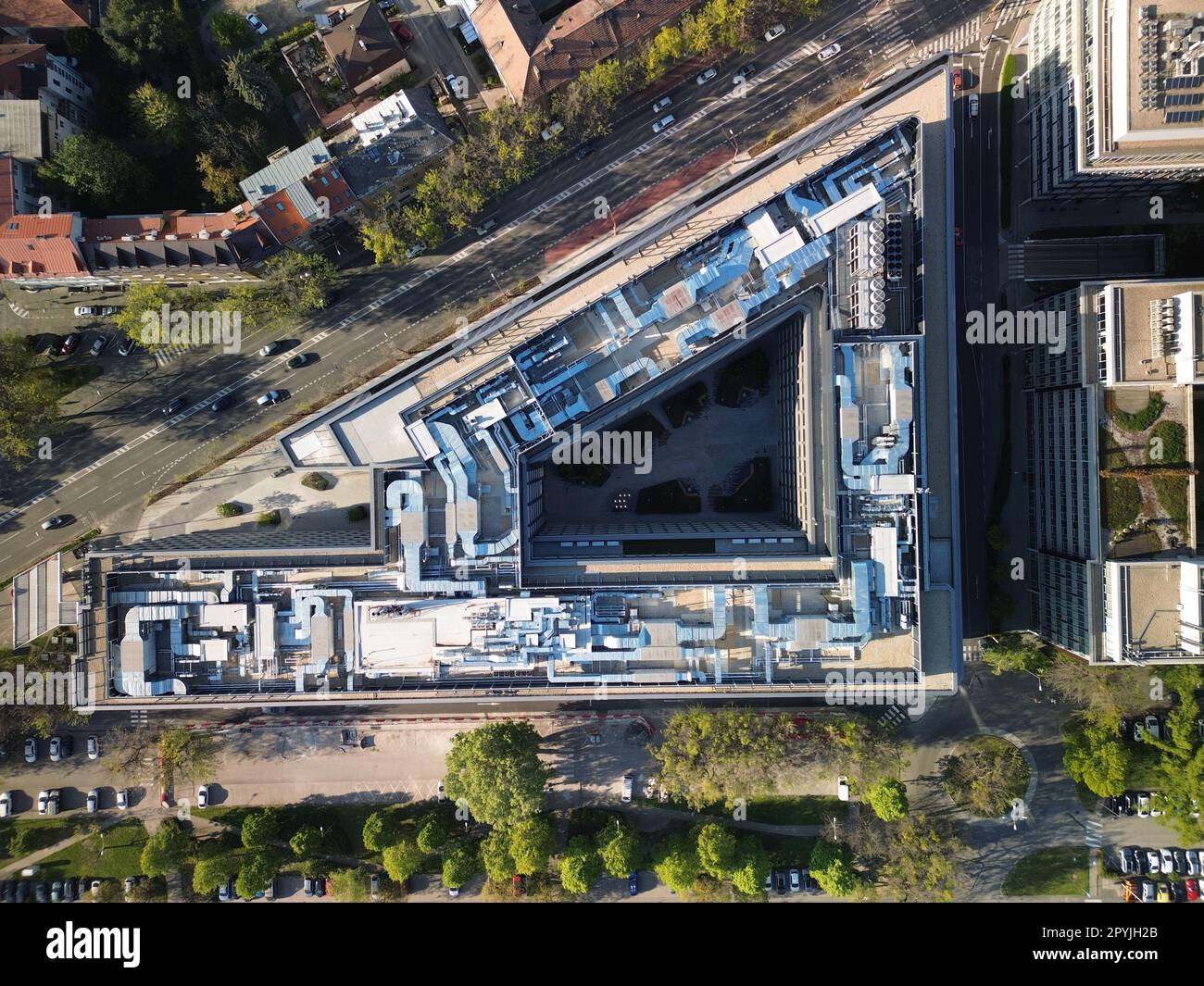 Aerial view of a bustling city street corner, with a variety of ...
