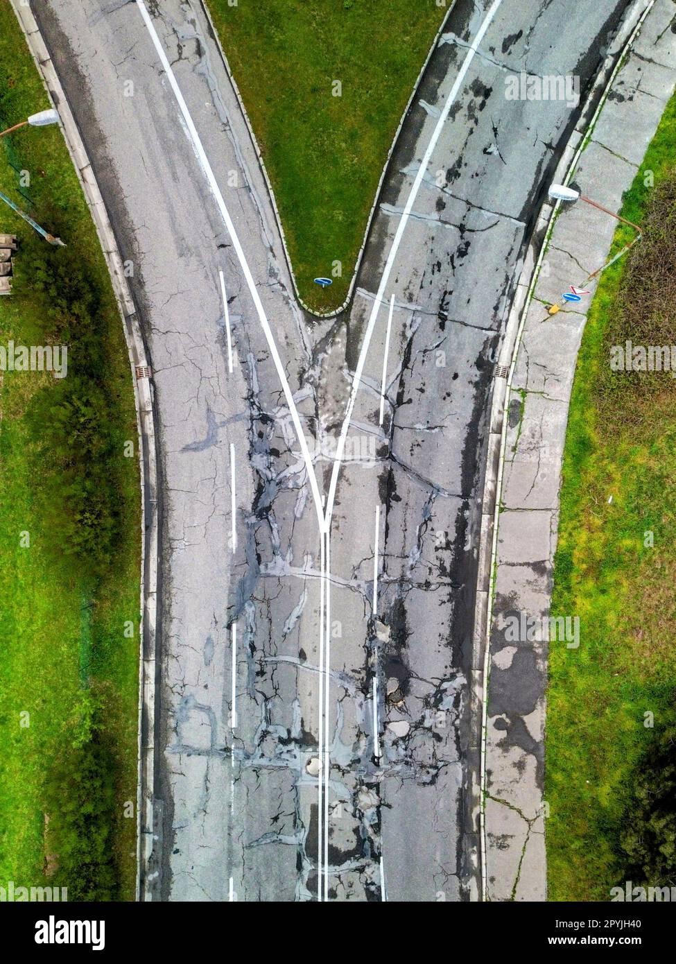 A shot of a damaged street with two lanes of traffic next to it Stock ...