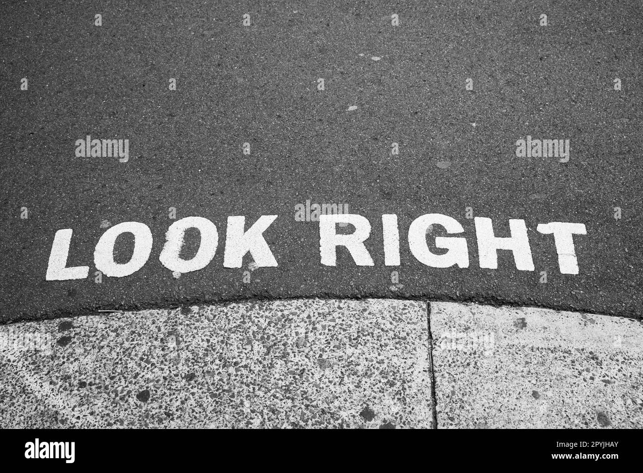 Look right sign painted on city road advising care when stepping of ...