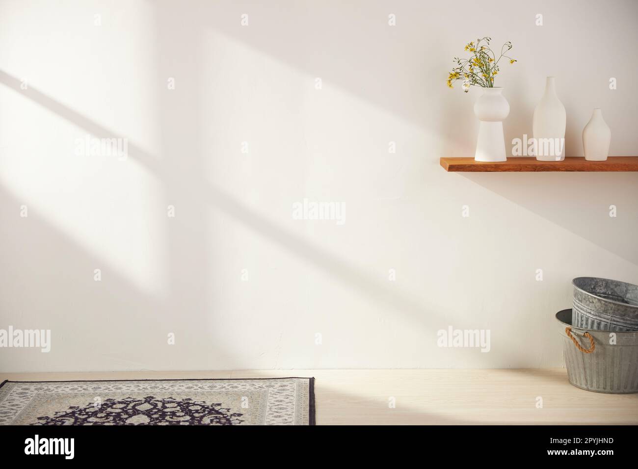 Vases and objects on the table in a warm room with sunlight coming in ...