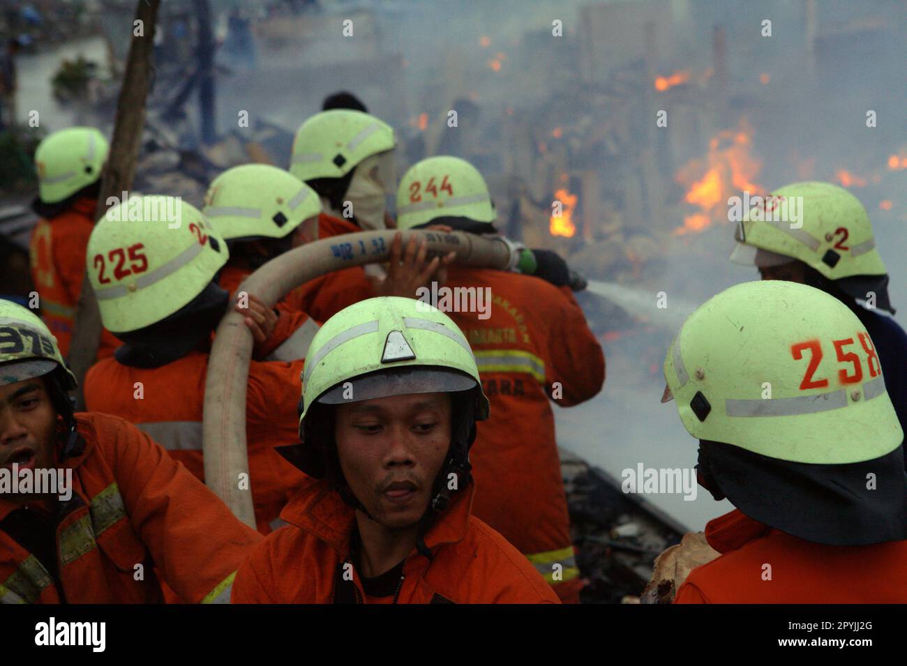 Firefighters performing the cooling phase after a fire accident burned ...