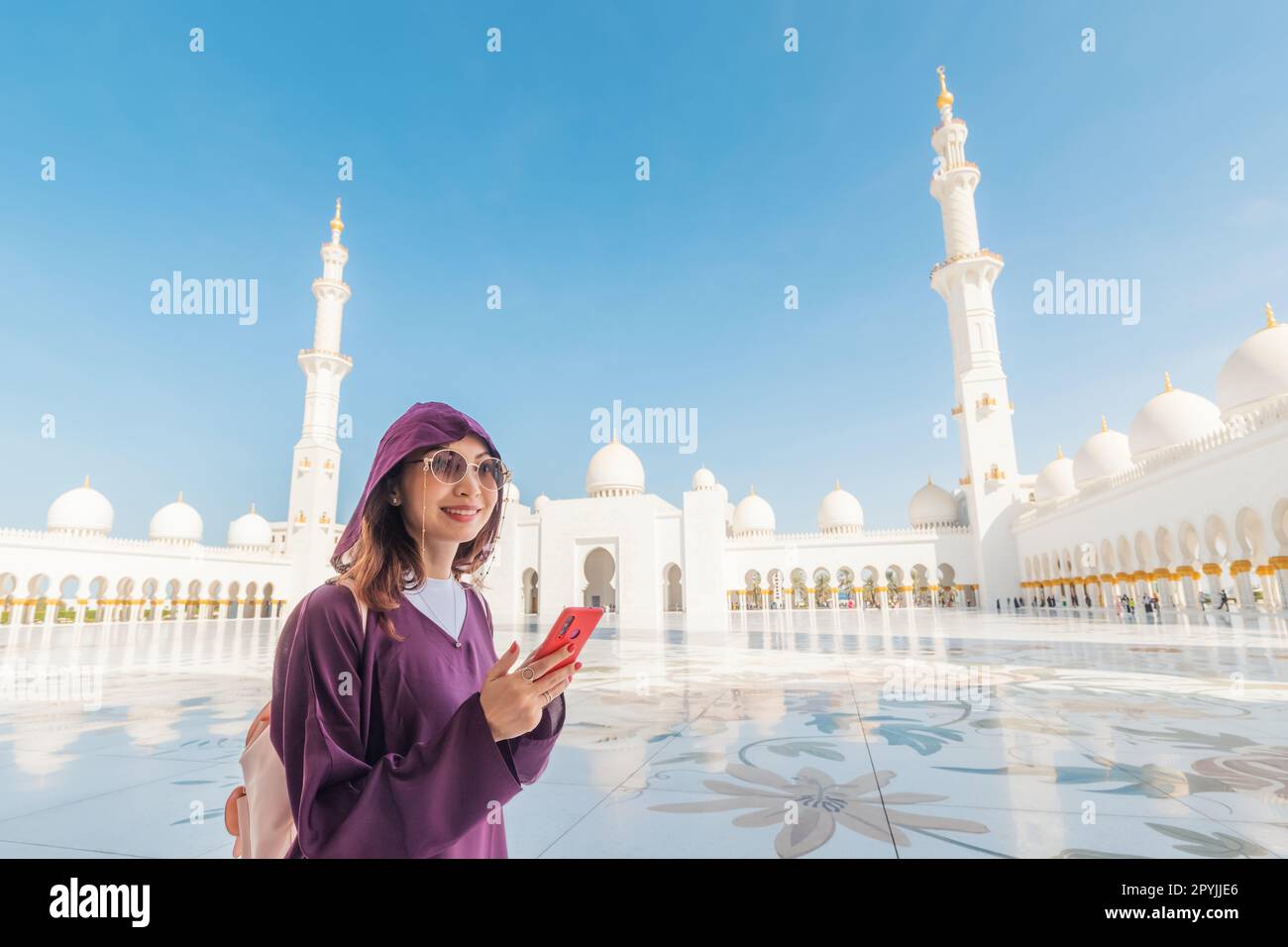 A tourist girl uses her phone to capture the stunning beauty of the ...