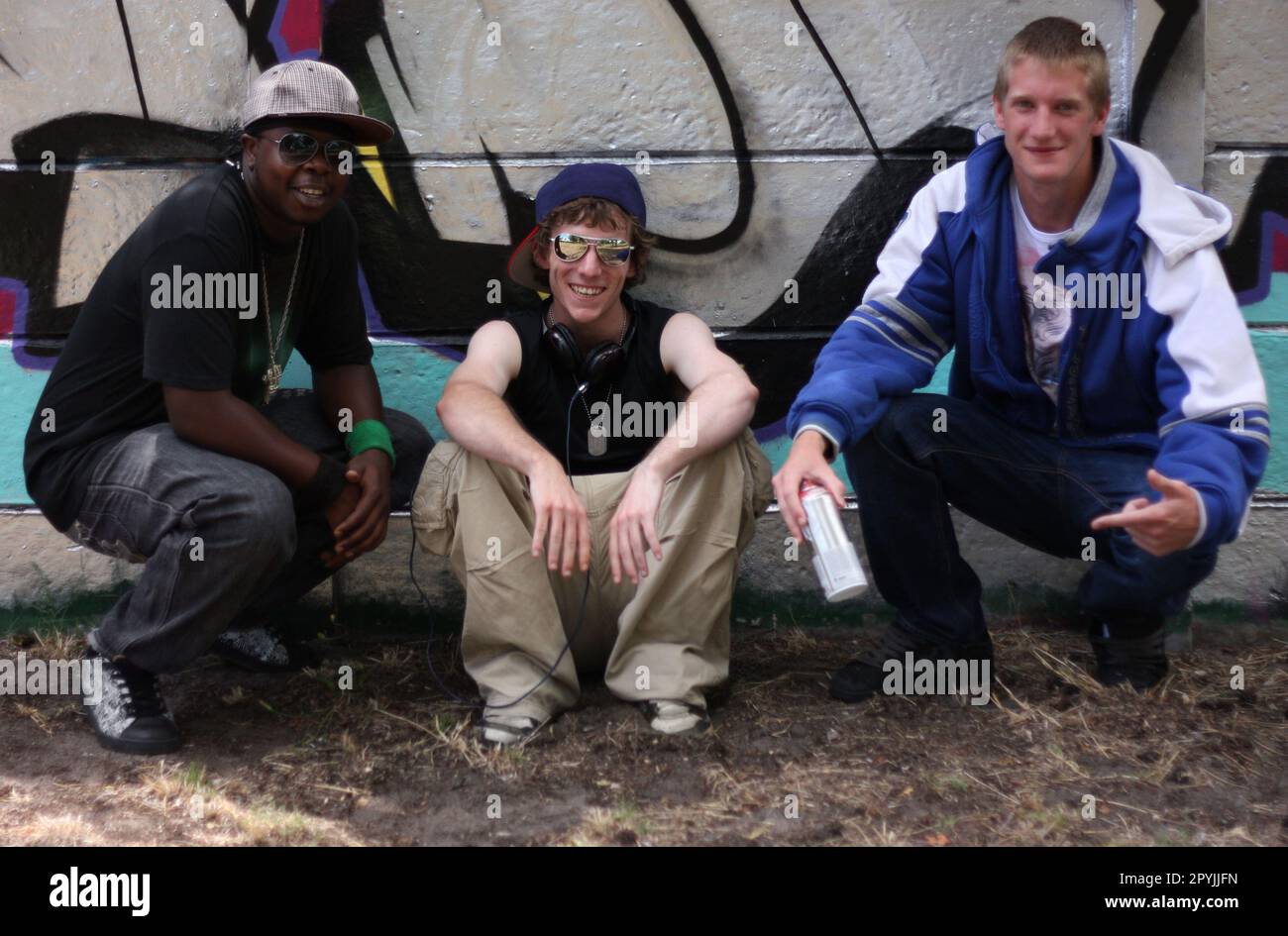 Graffiti, street art and portrait of friends by wall with spray can for ...