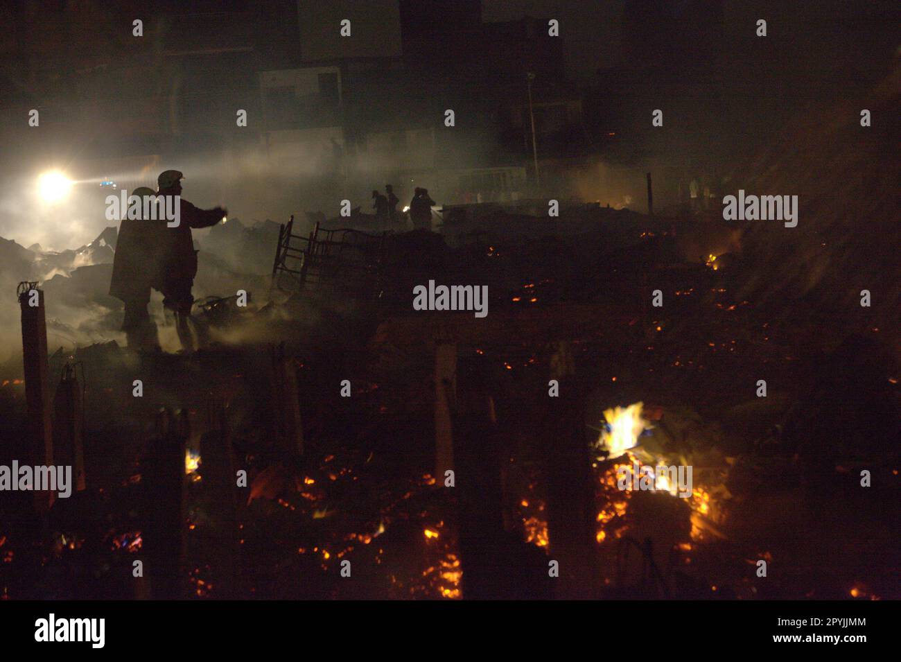 Firefighters performing the cooling phase after a fire accident burned ...