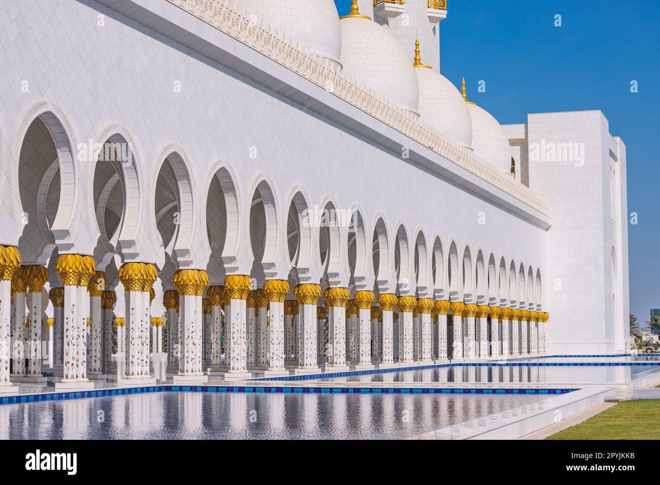 Majestic arches tower over a tranquil pool in the stunning Sheikh Zayed ...